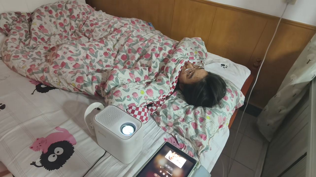 Ceiling TV binge: Girl's cozy projector setup