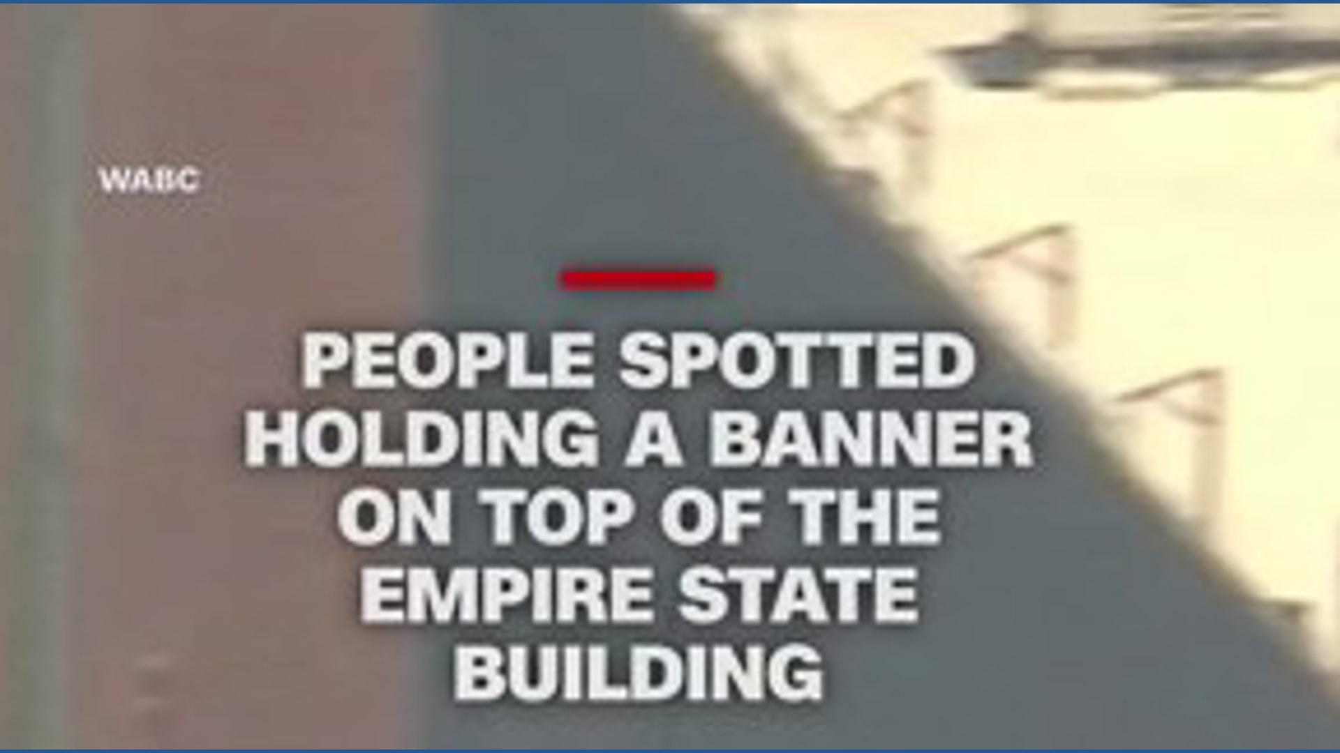 People spotted holding a banner on top of the Empire State Building