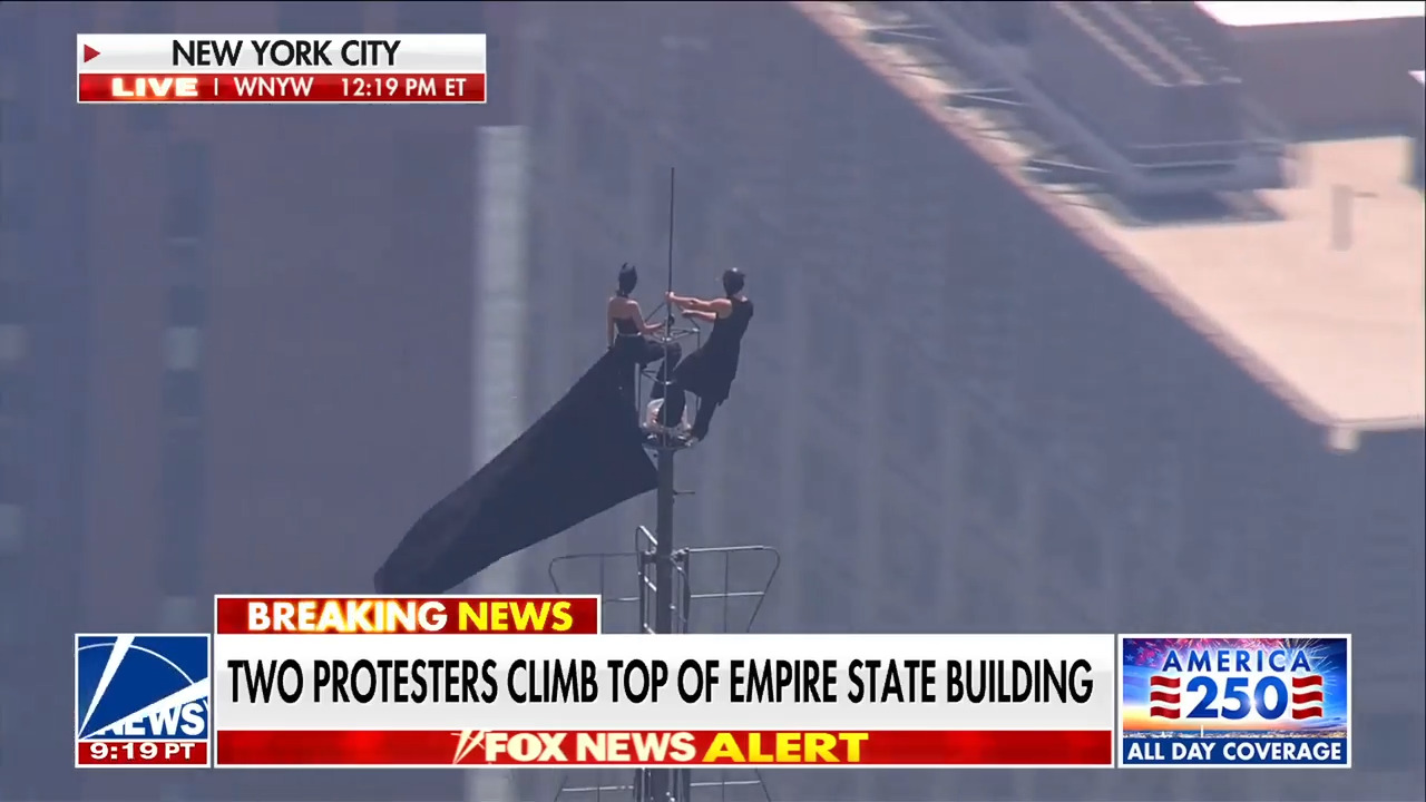 Masked protesters scale Empire State Building spire