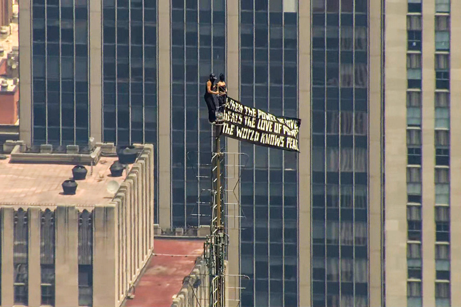 Two trespassers climb to top of Empire State Building, fly pro-peace banner