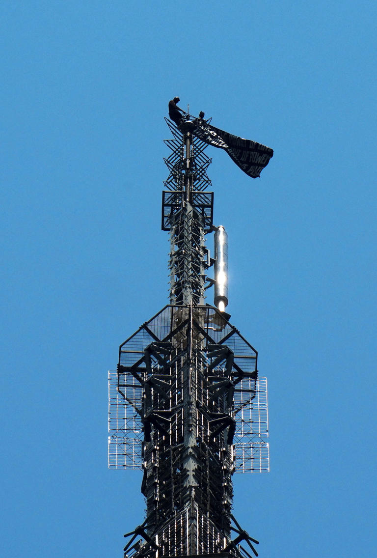 Two people scale Empire State Building and fly banner