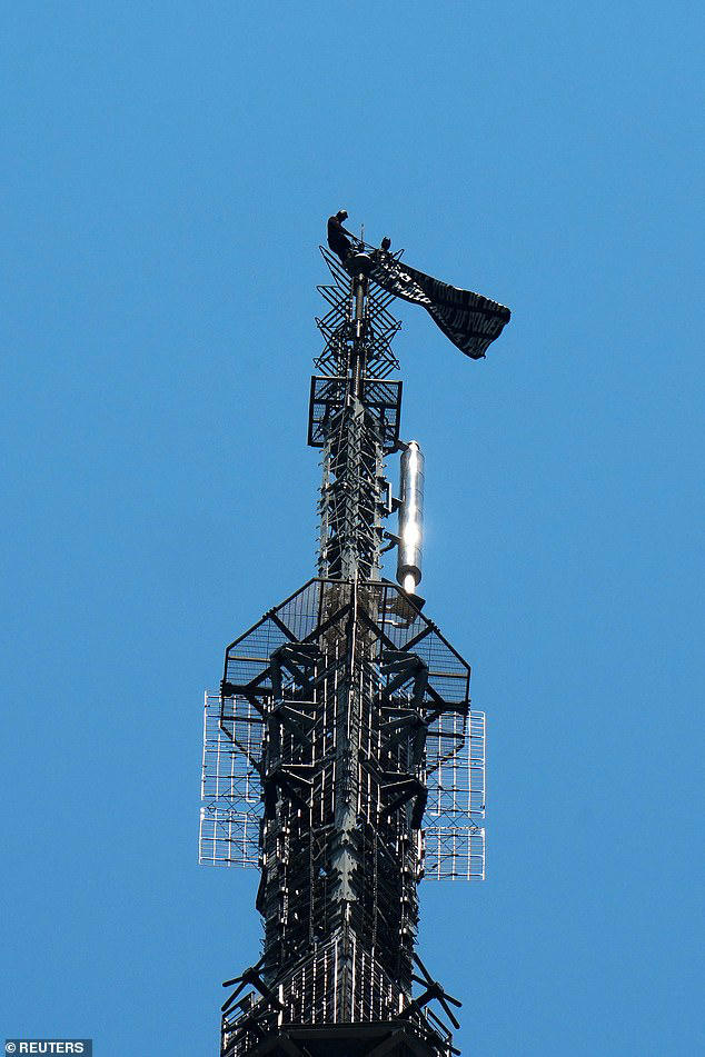 Masked pair scale Empire State Building to very top and fly banner ...