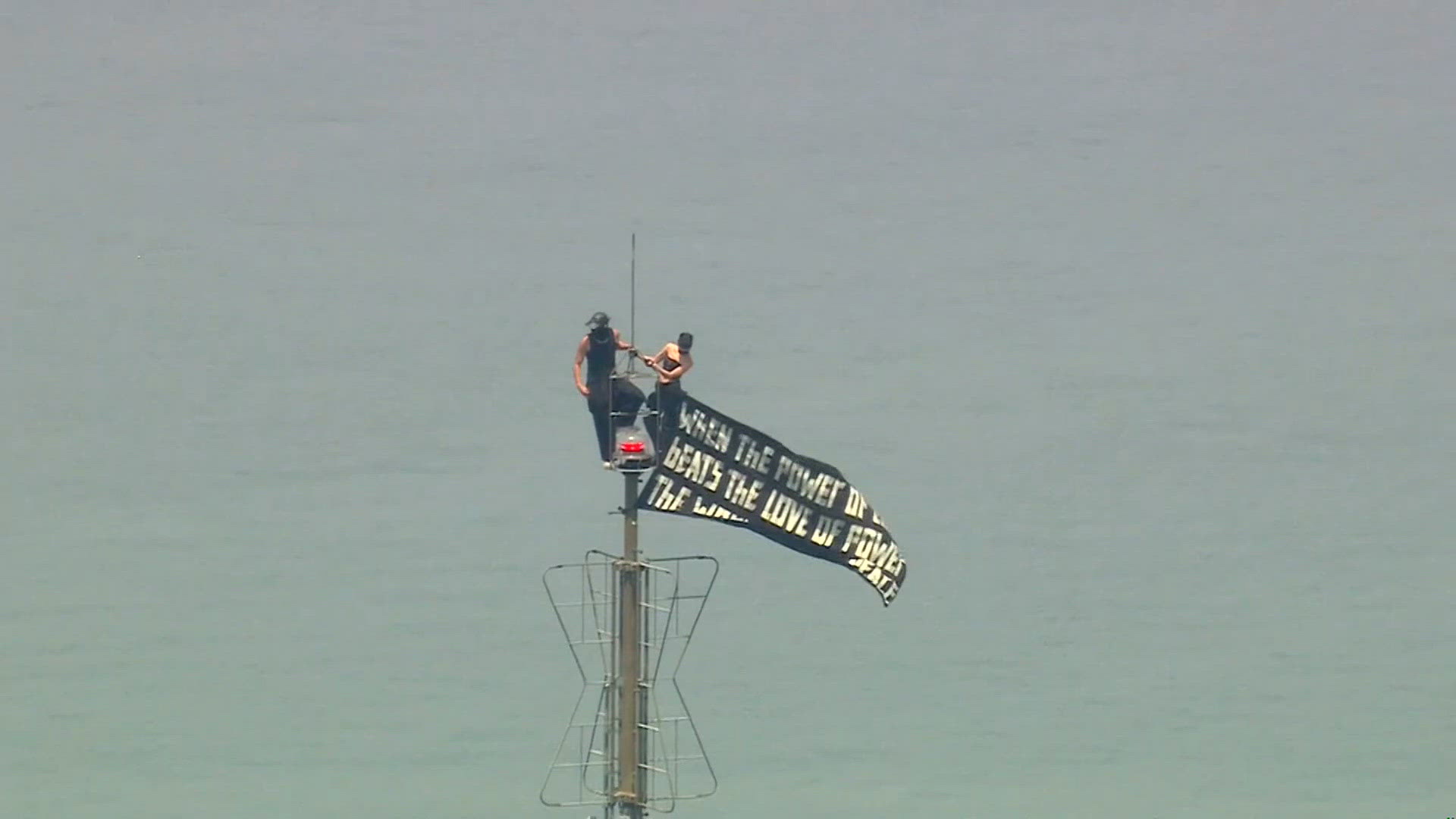 2 people arrested after hanging banner about 'the power of love' on ...