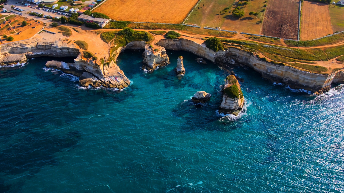 Towering sea stacks rising from brilliant blue waters