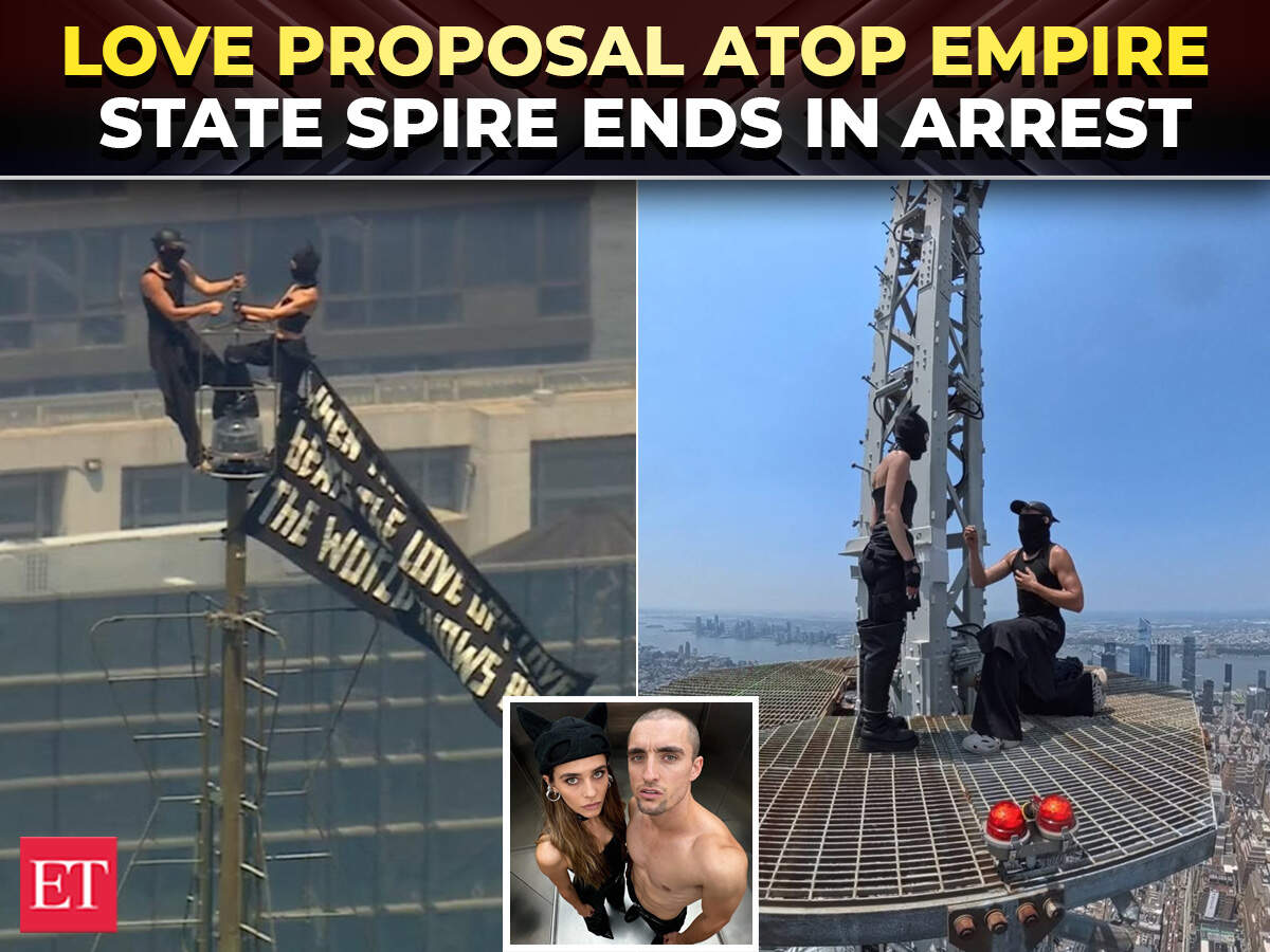 Couple climbs NYC Empire State spire, kisses, gets engaged, unfurls ...