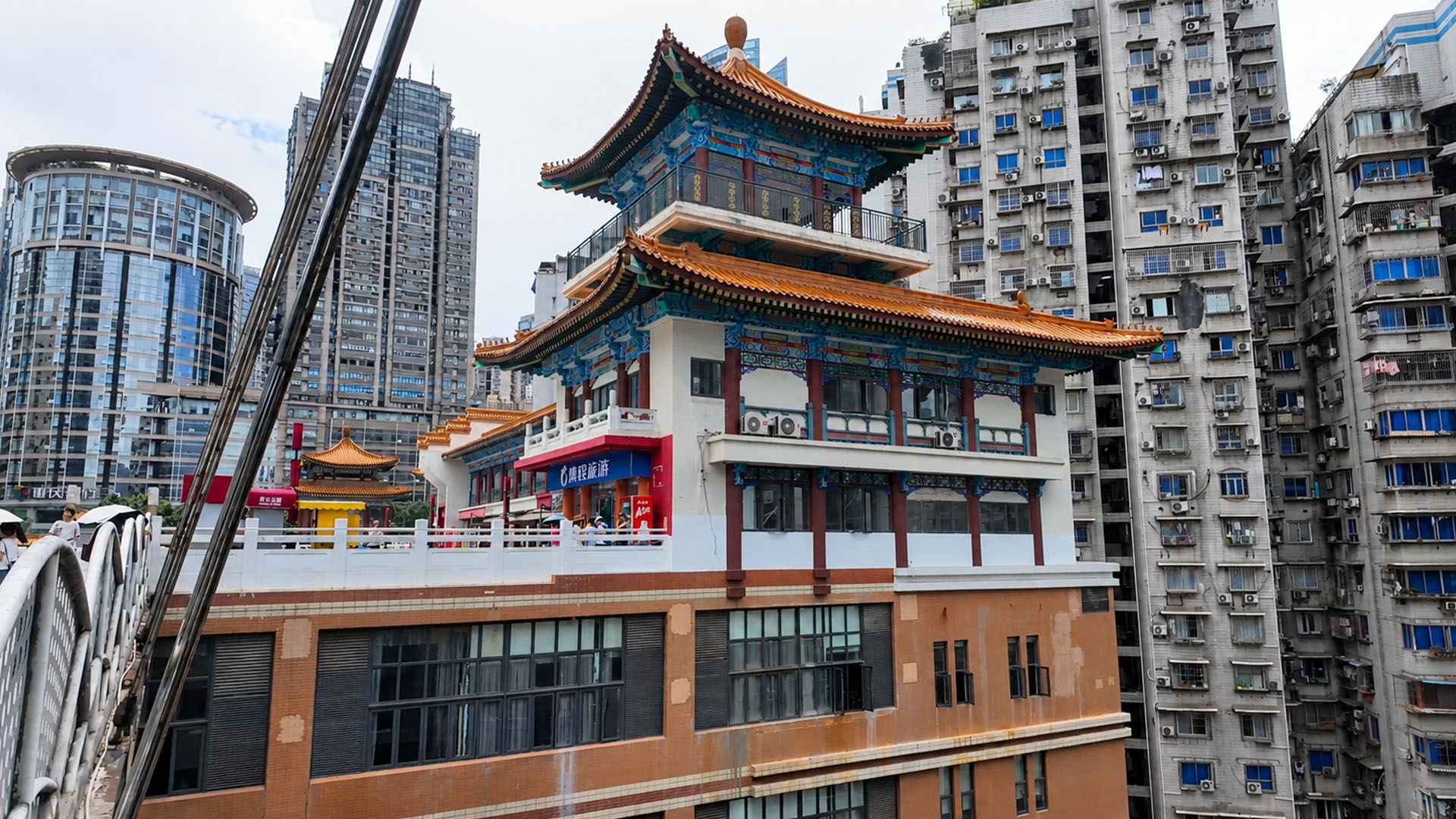 A traditional Chinese pavilion standing between modern high-rise buildings