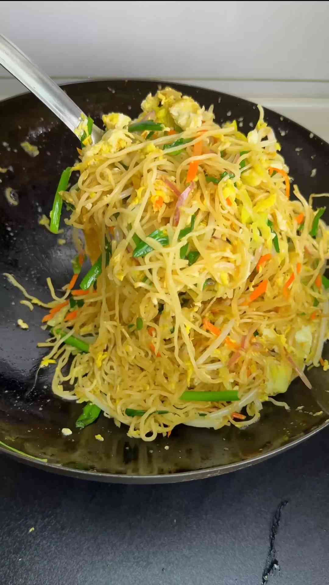Street style fried noodles cooked in a giant wok