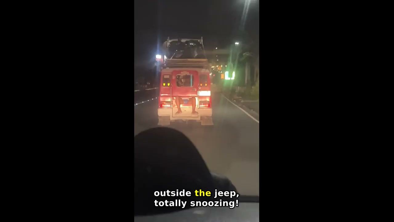 Man naps with feet out the Jeep window in Manila