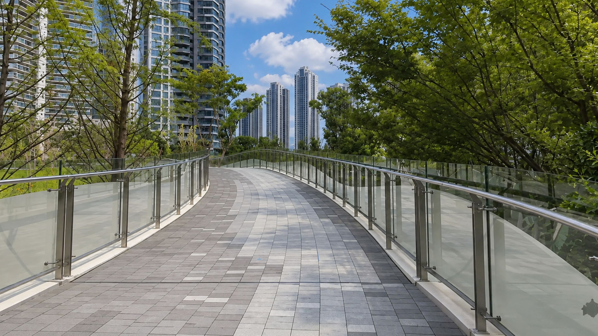 Wide curved pedestrian bridge leads toward modern residential tower ...