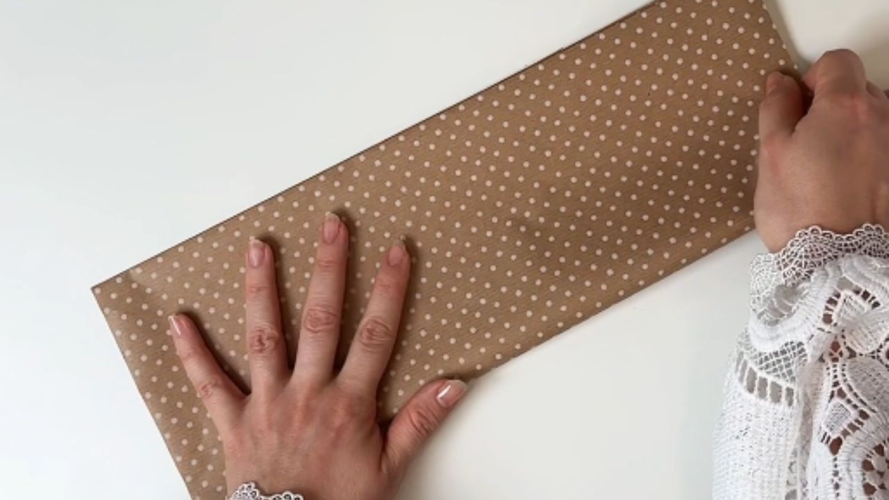 Girl creates a chic gift bag with wrapping paper and folds