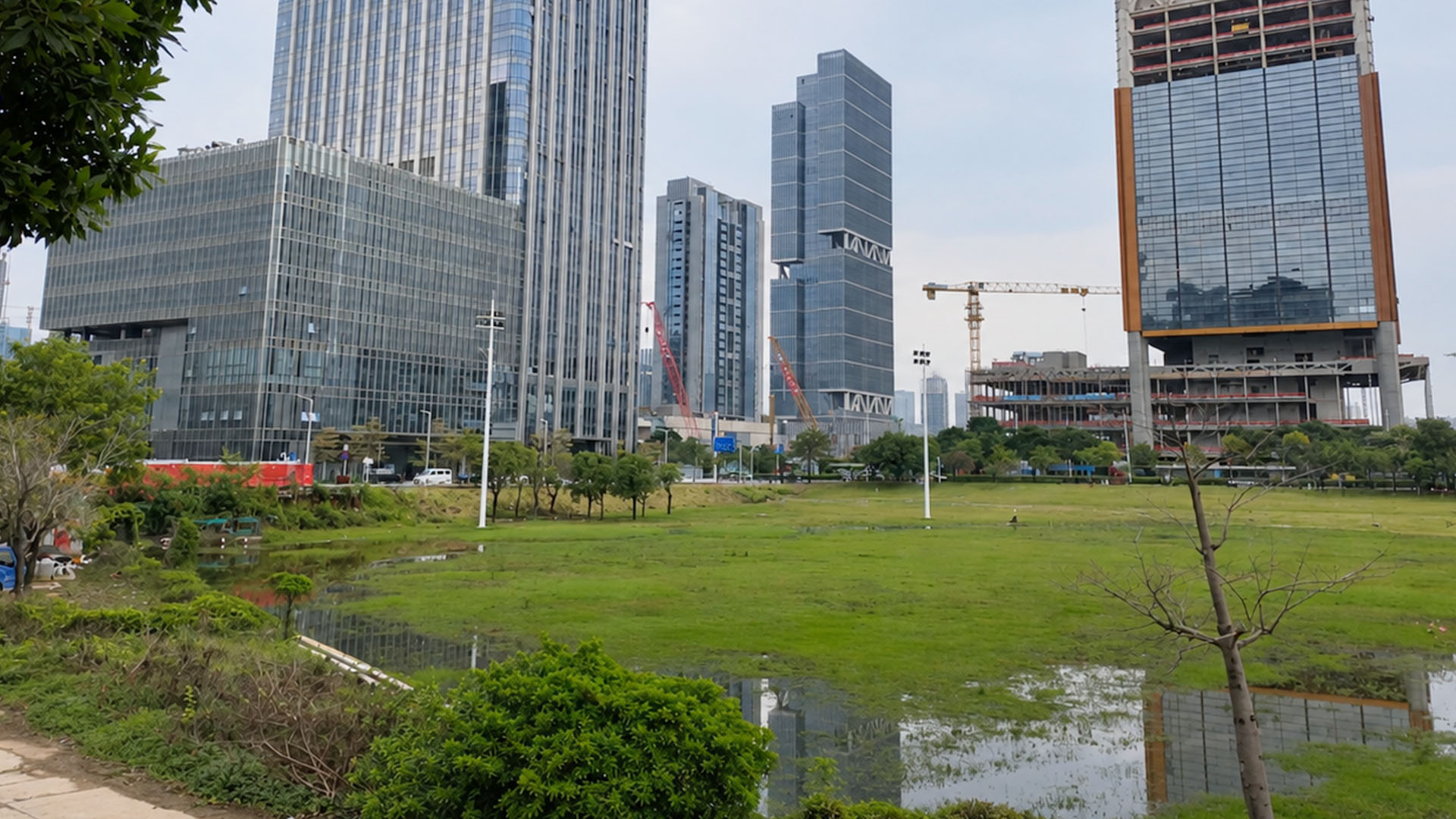 China’s modern skyscrapers rise beside a vast green field