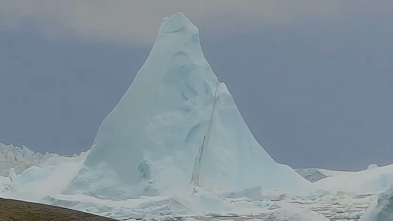 Watch what looks like a mountain drift across Greenland... it's ...