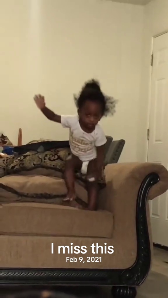Toddler with wild hair turns the couch into a playground