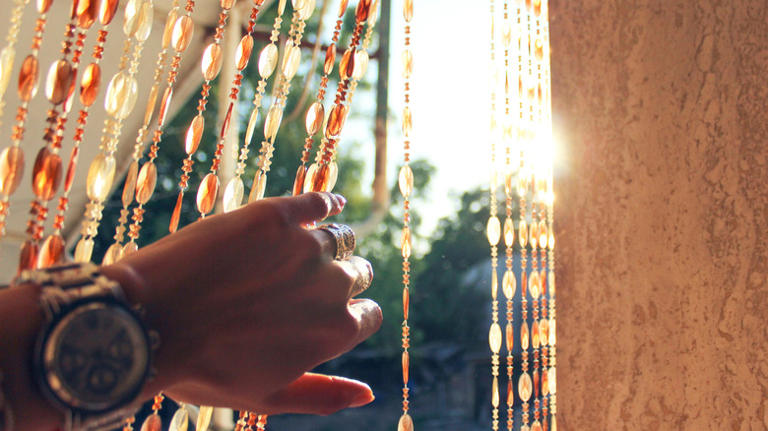 Use simple binder rings to DIY the coolest beaded curtains