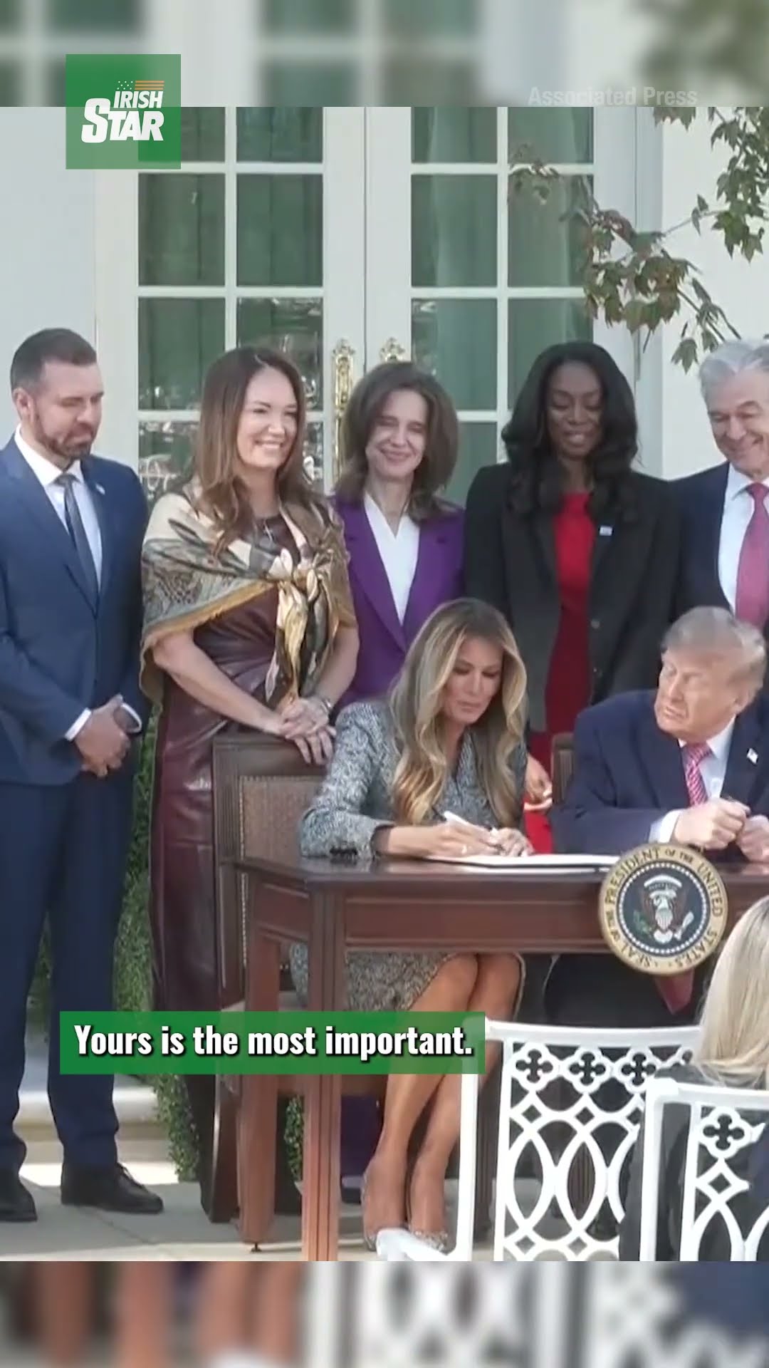Melania Trump signs executive order during presidential speech