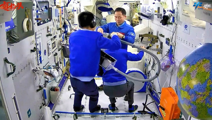 Astronauts giving haircuts to one another onboard Chinese space station