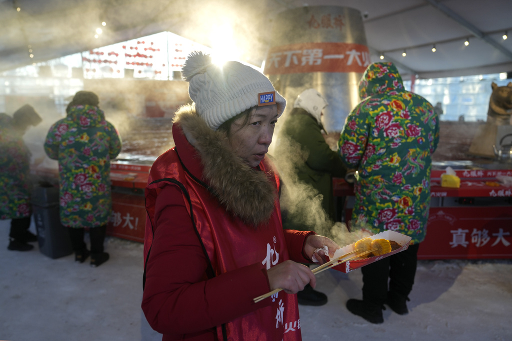 AP PHOTOS: Warm clothing, hot pot and even ice cream bars feature at China's ice capital