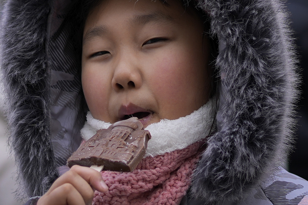 AP PHOTOS: Warm clothing, hot pot and even ice cream bars feature at ...
