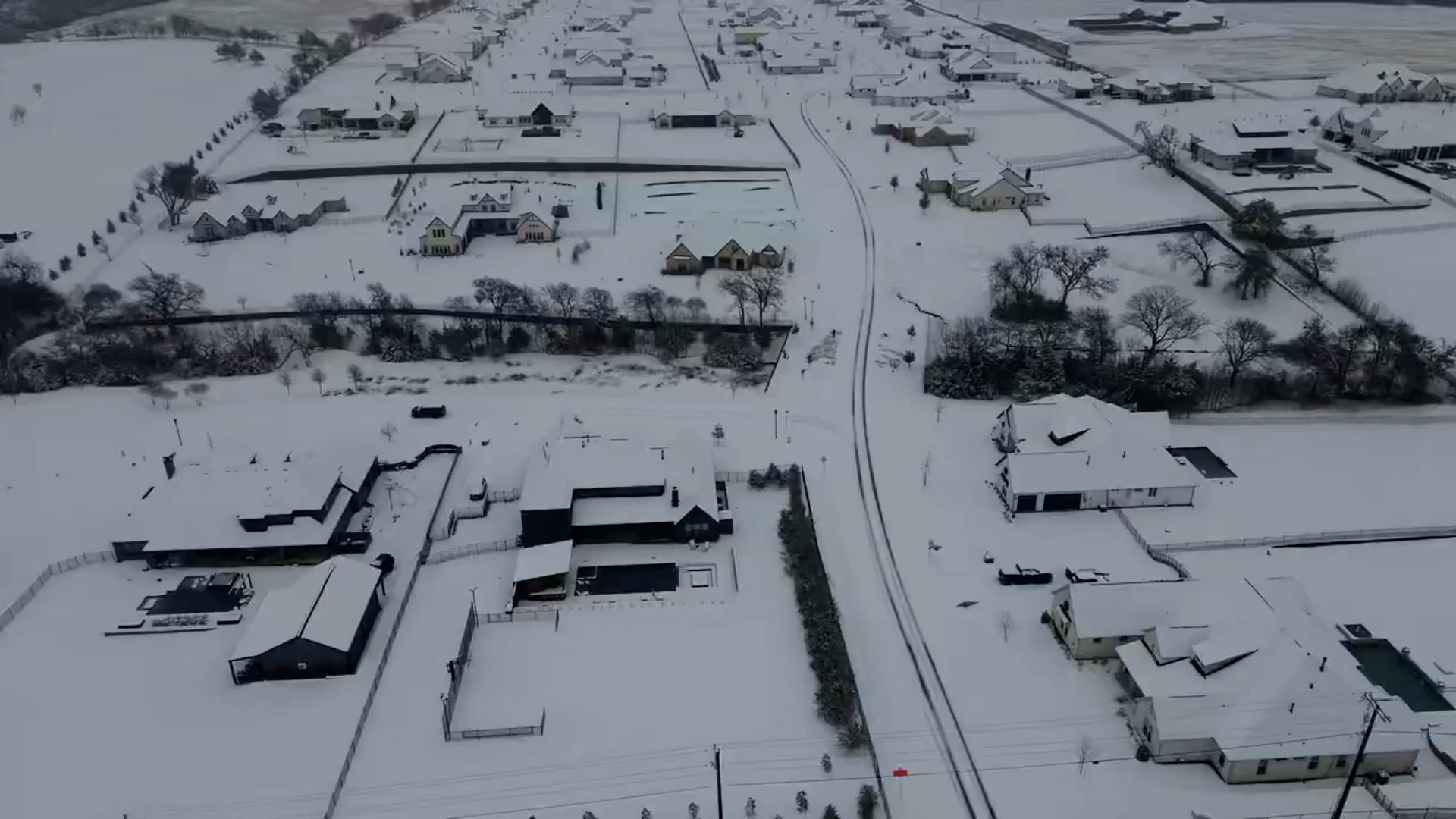 Drone video shows snow-covered neighborhoods in Texas