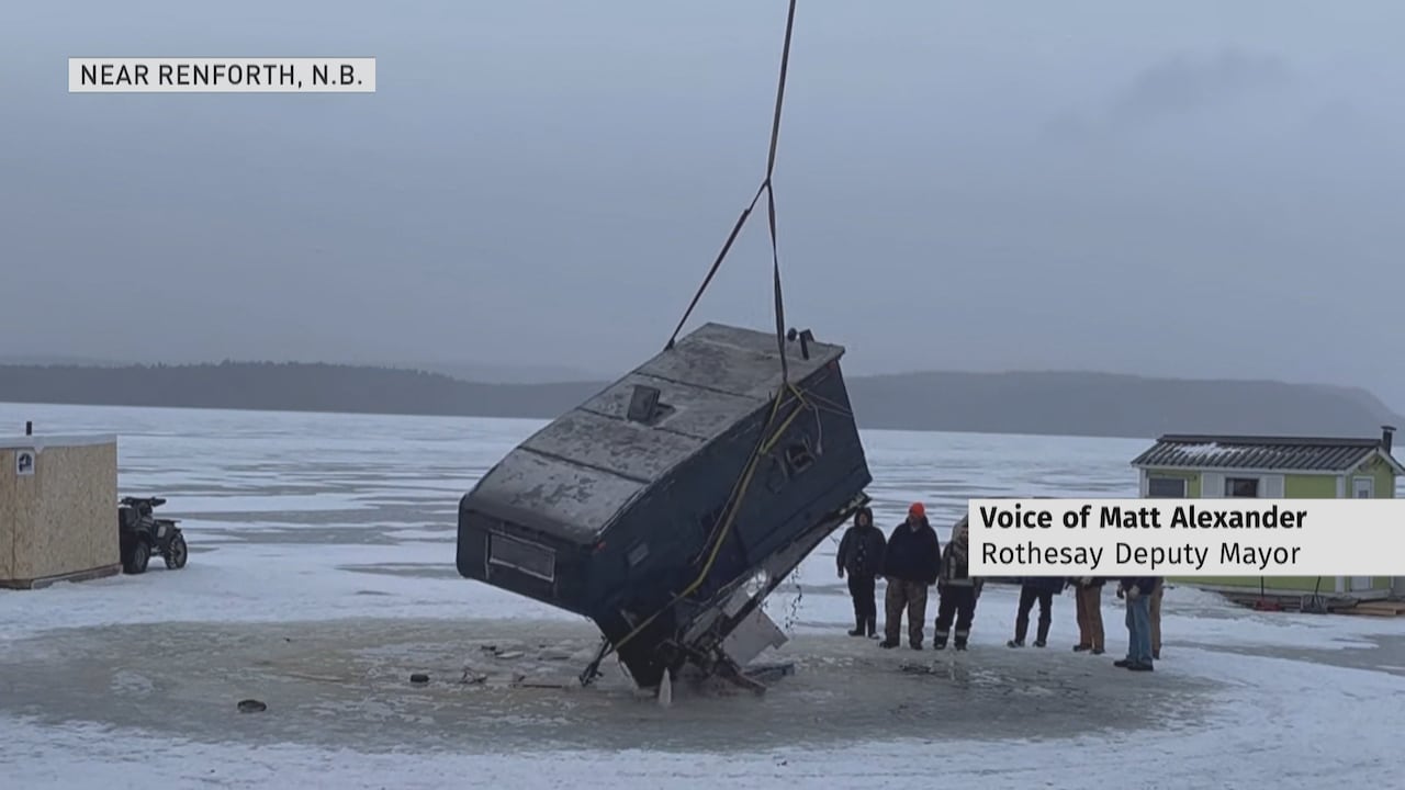 Sunken ice-fishing shack hauled from the water by crane